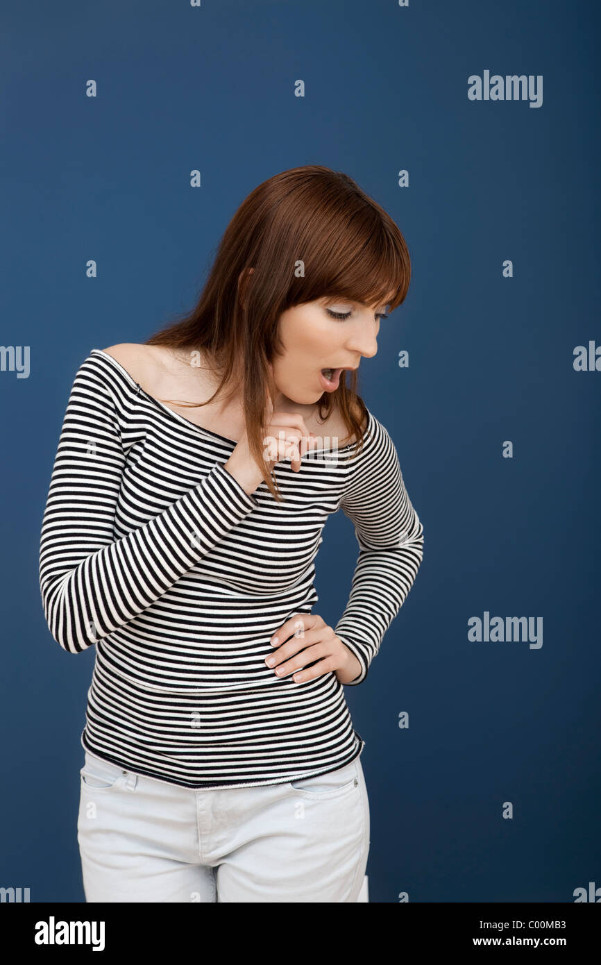 Beautiful young woman looking down over a blue background Stock Photo ...
