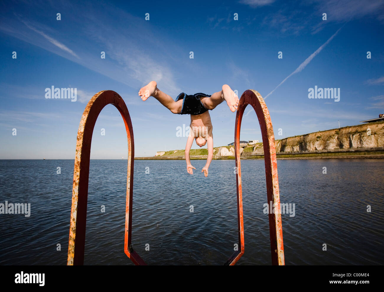 Boy jumping to swimming pool Stock Photo - Alamy