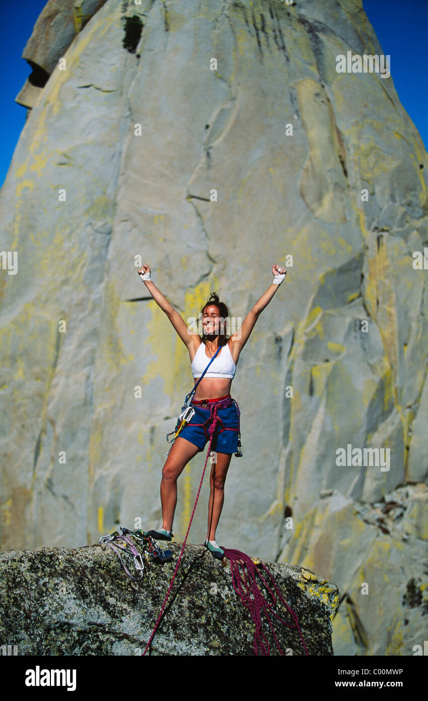 Female rock climber celebrates on the summit of a rock pinnacle Stock ...