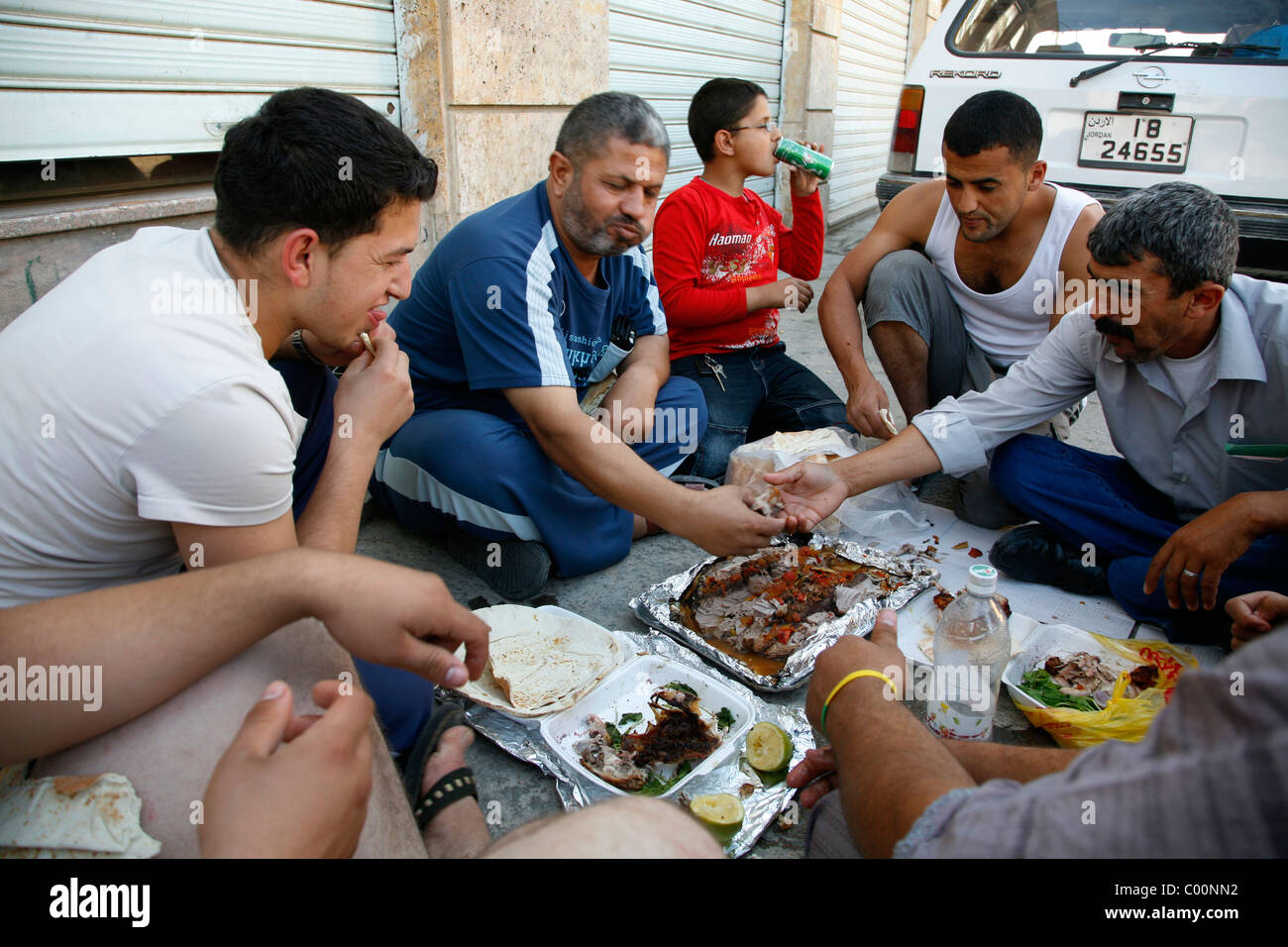 People eating togther on the street, Aqaba, Jordan Stock Photo - Alamy