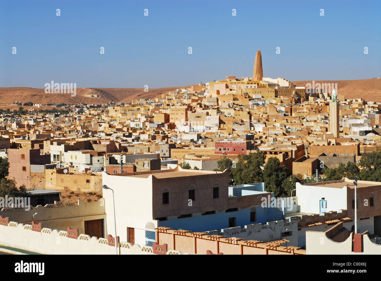 Algeria, Ghardaia, view of city with mud-brick dwelling and tall ...