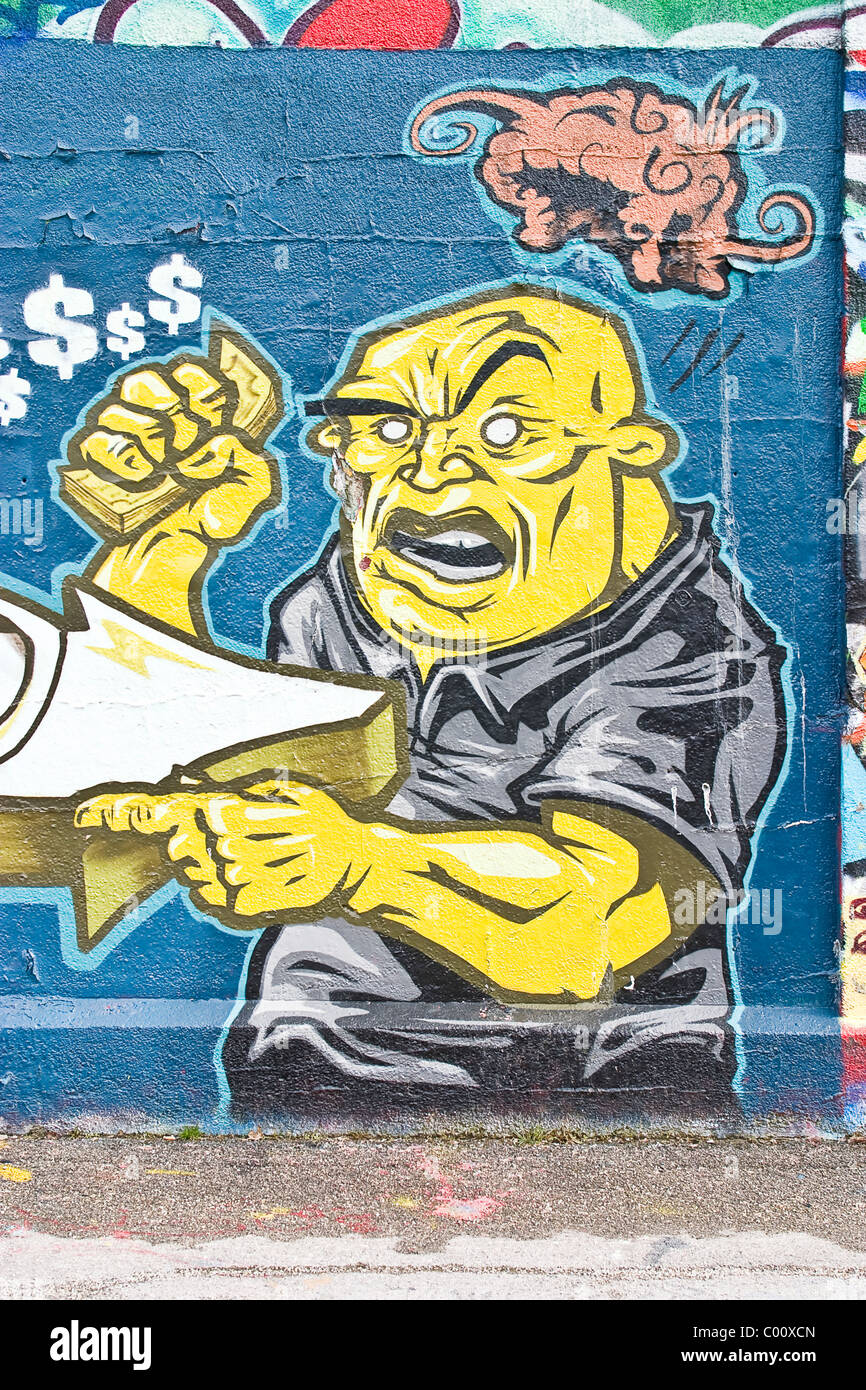 Graffiti of a yellow man holding bank notes. Concept greed Stock Photo ...