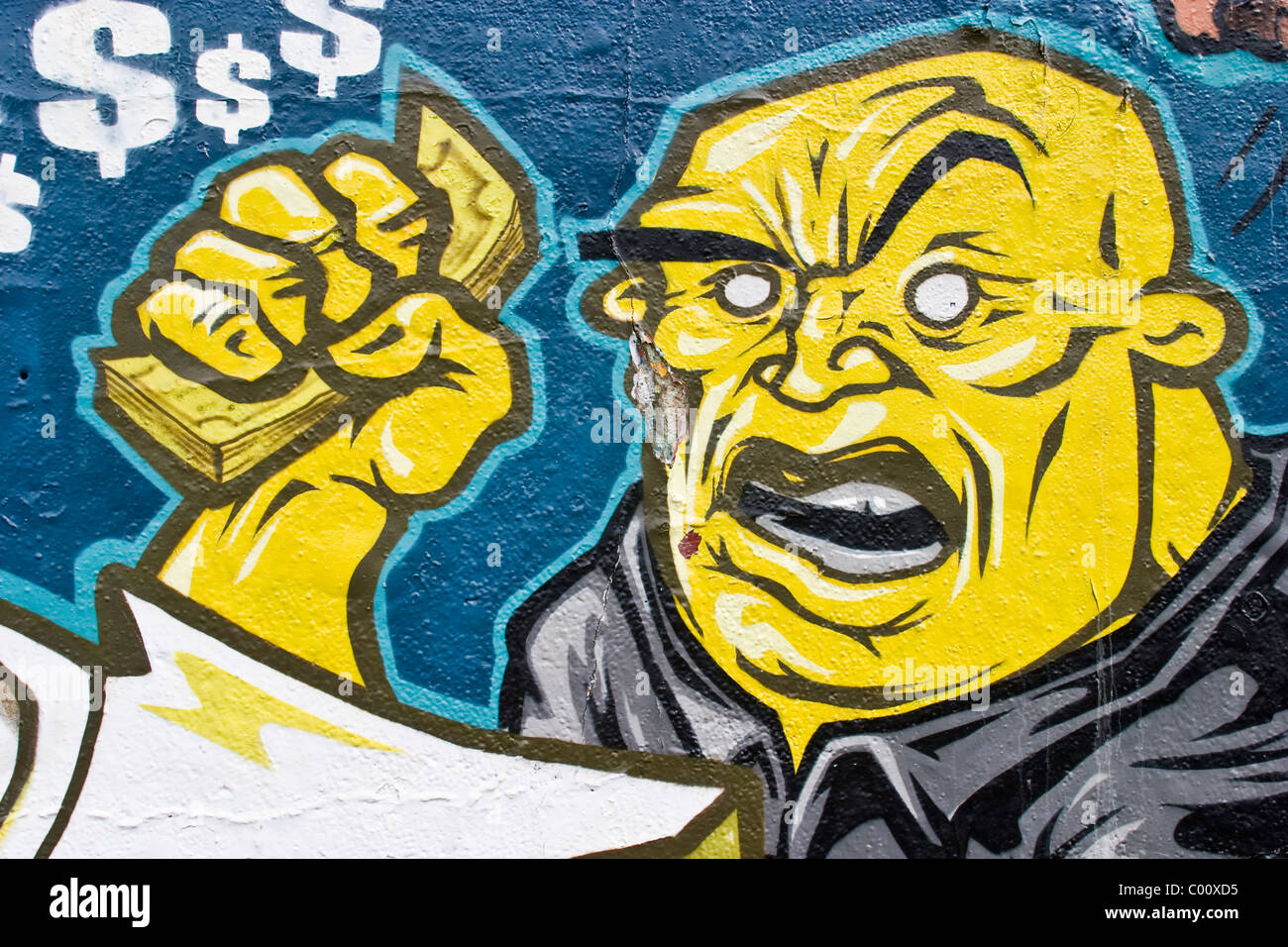 Graffiti of a yellow man holding bank notes. Concept greed Stock Photo ...