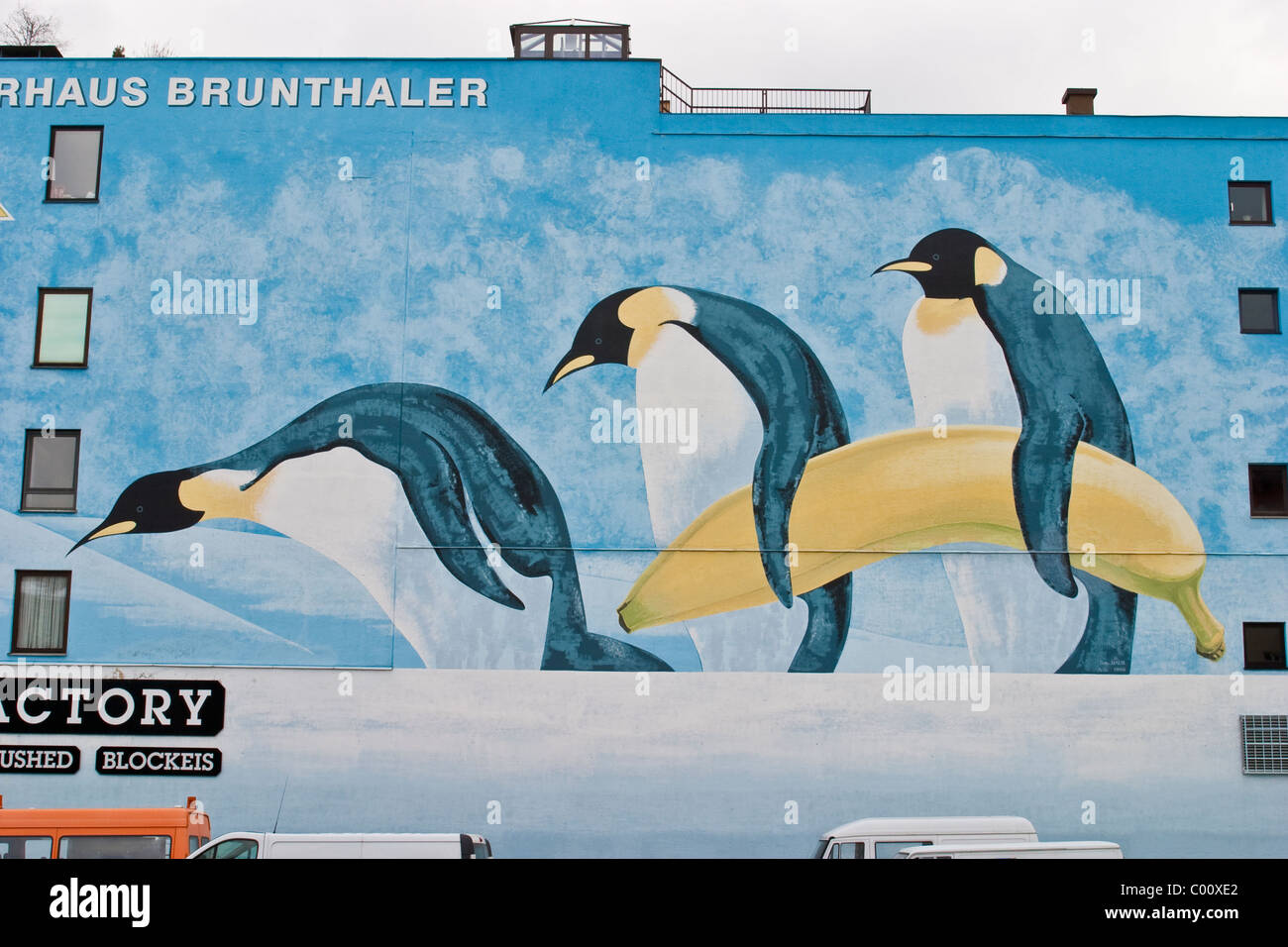 Graffiti on a wall. Three penguins carrying a banana Stock Photo - Alamy
