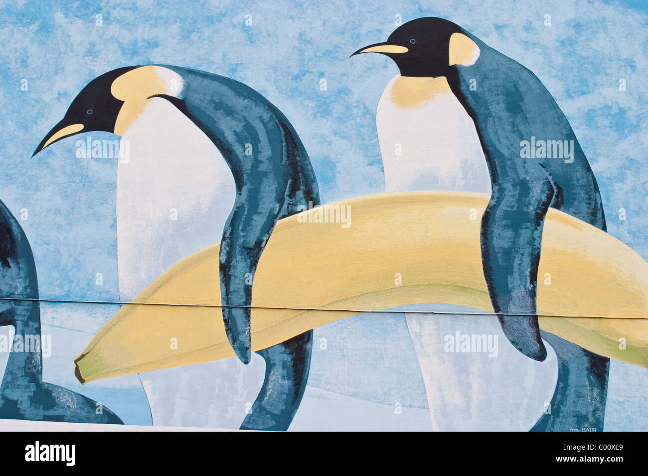 Graffiti on a wall. Two penguins carrying a banana Stock Photo - Alamy