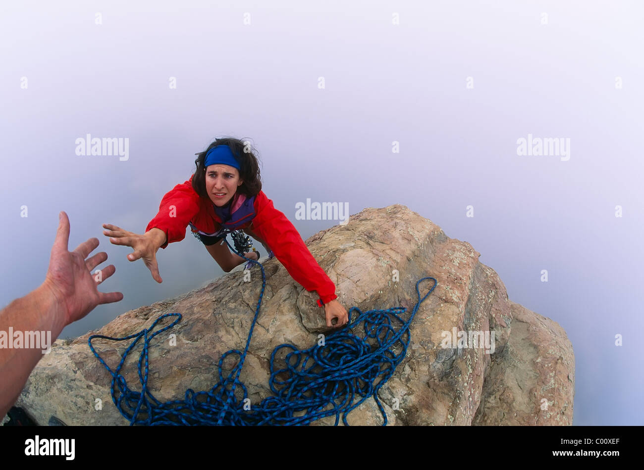 Female climber reaching the summit Stock Photo - Alamy