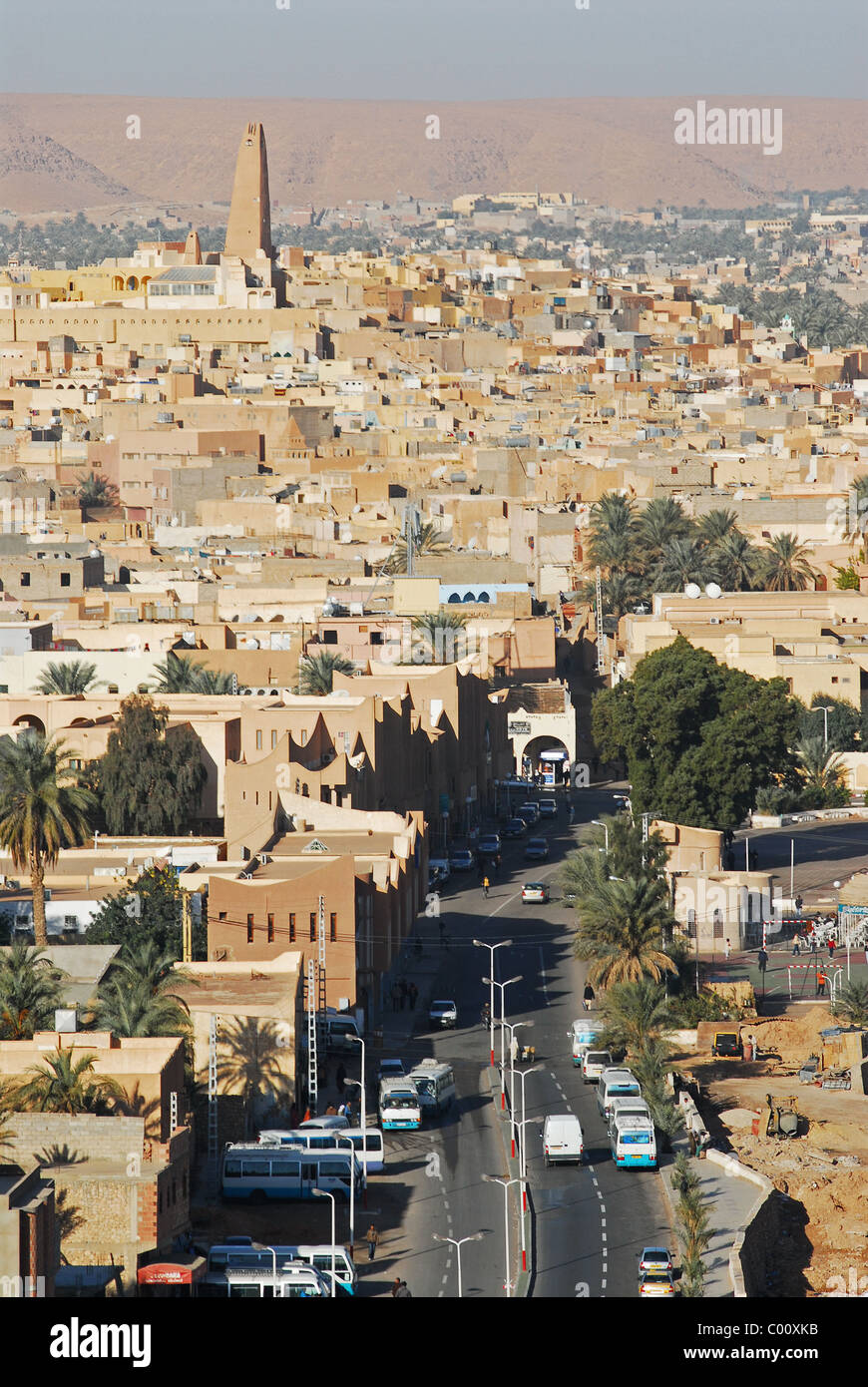 Algeria, Ghardaia, view of city with vehicles on road, mud-brick ...