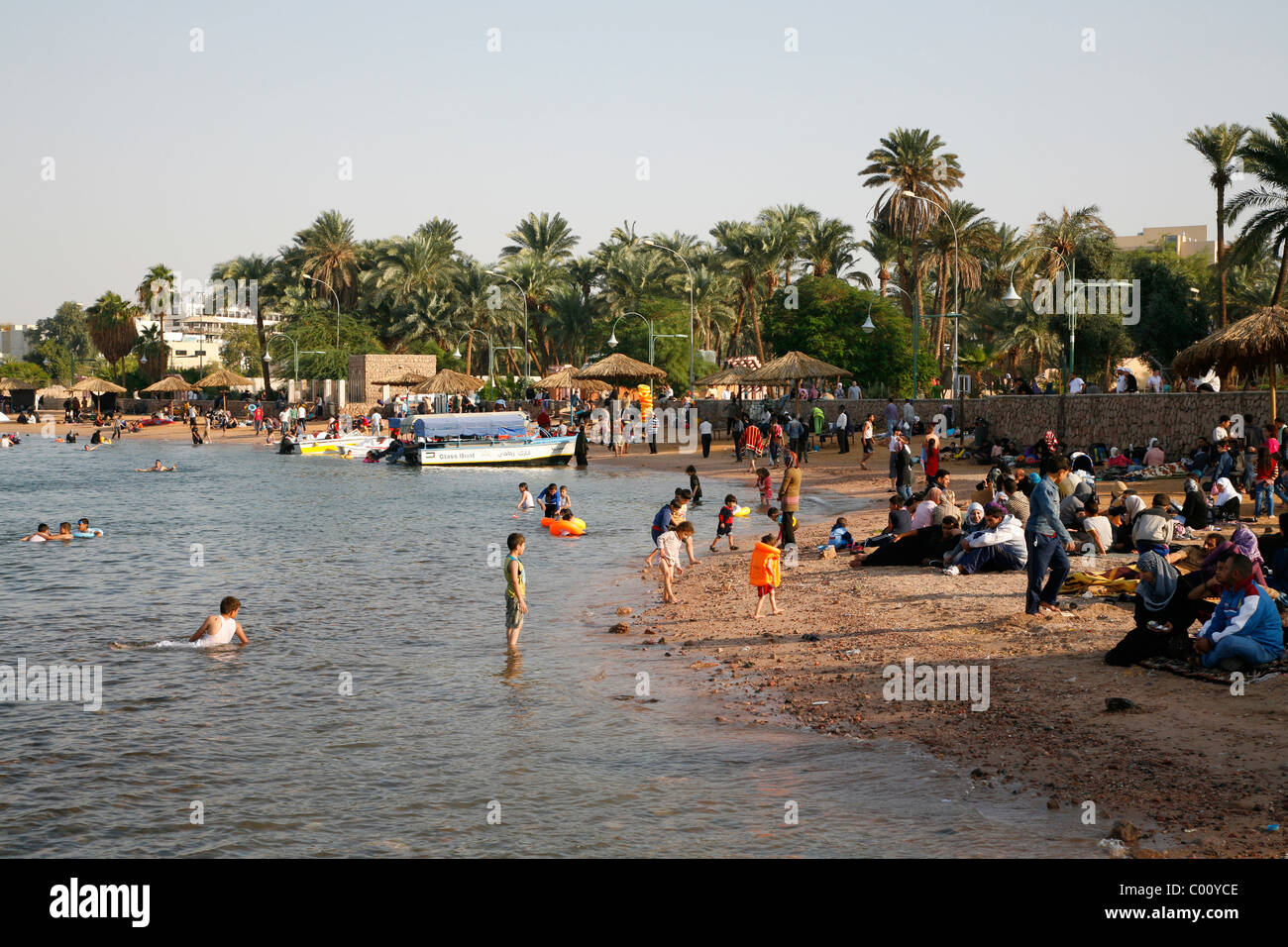 People on the public beach of Aqaba, Jordan Stock Photo - Alamy