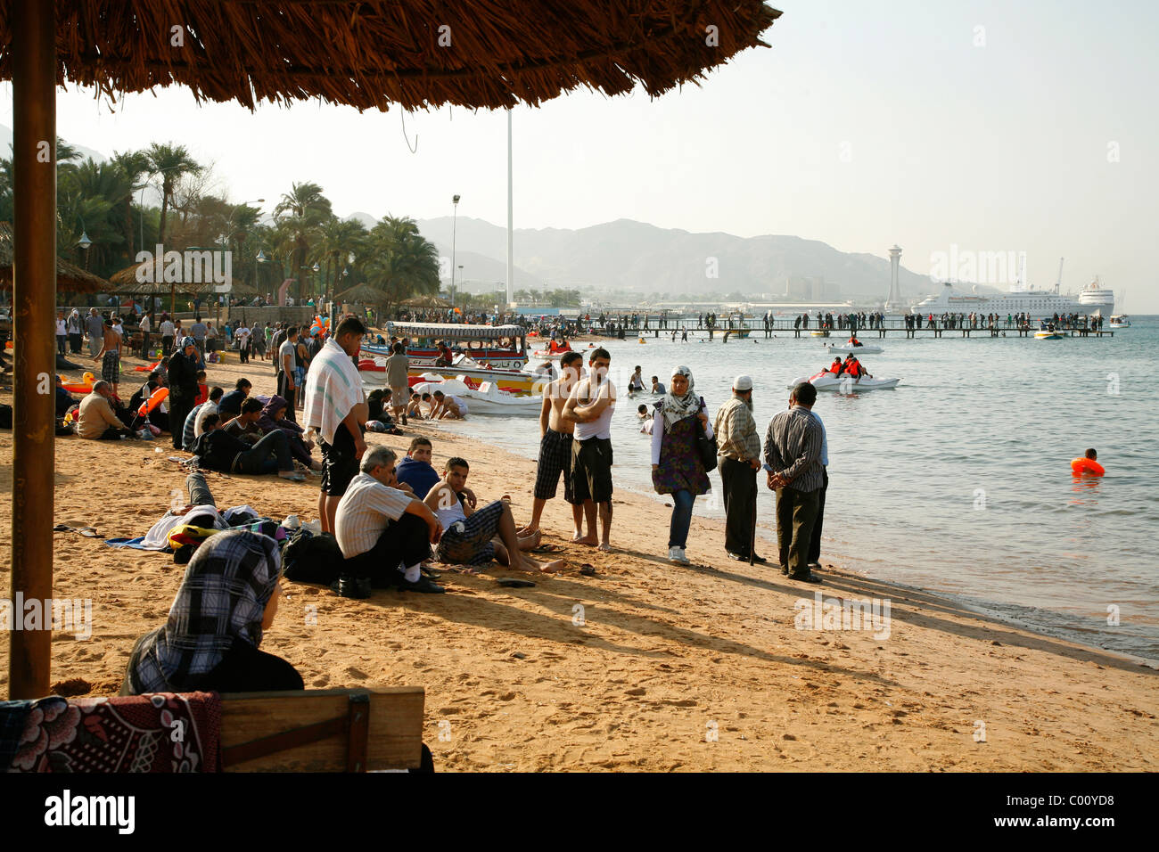 People on the public beach of Aqaba, Jordan Stock Photo - Alamy