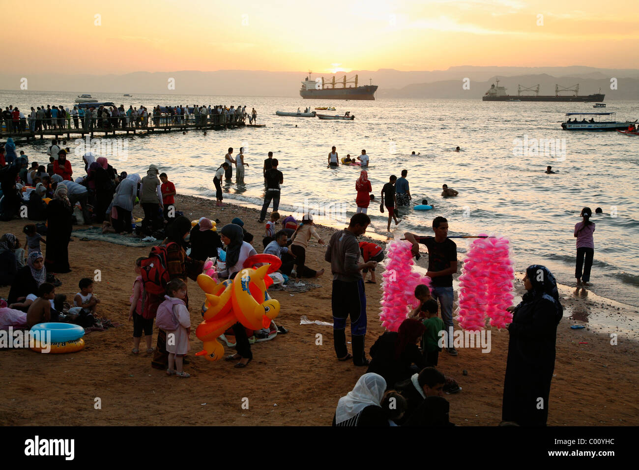People on the public beach of Aqaba, Jordan Stock Photo - Alamy