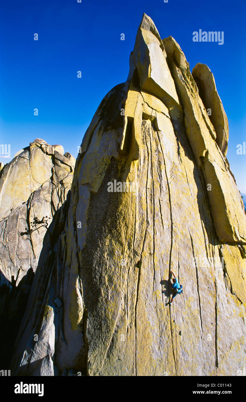 Male rock climber clinging to a cliff Stock Photo - Alamy
