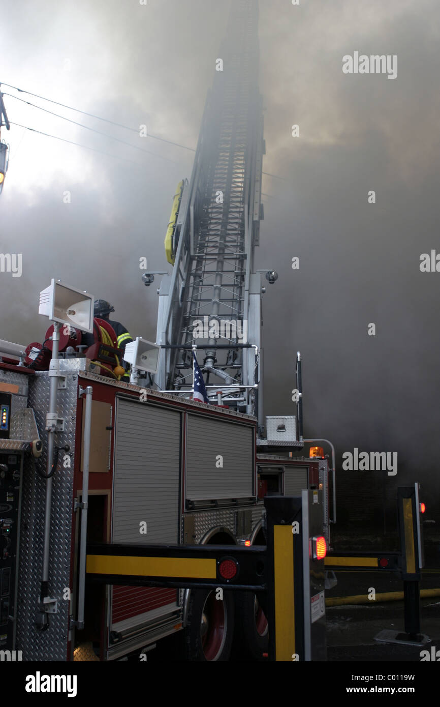 Ladder truck being used as a water tower at scene of a large fire in NJ ...
