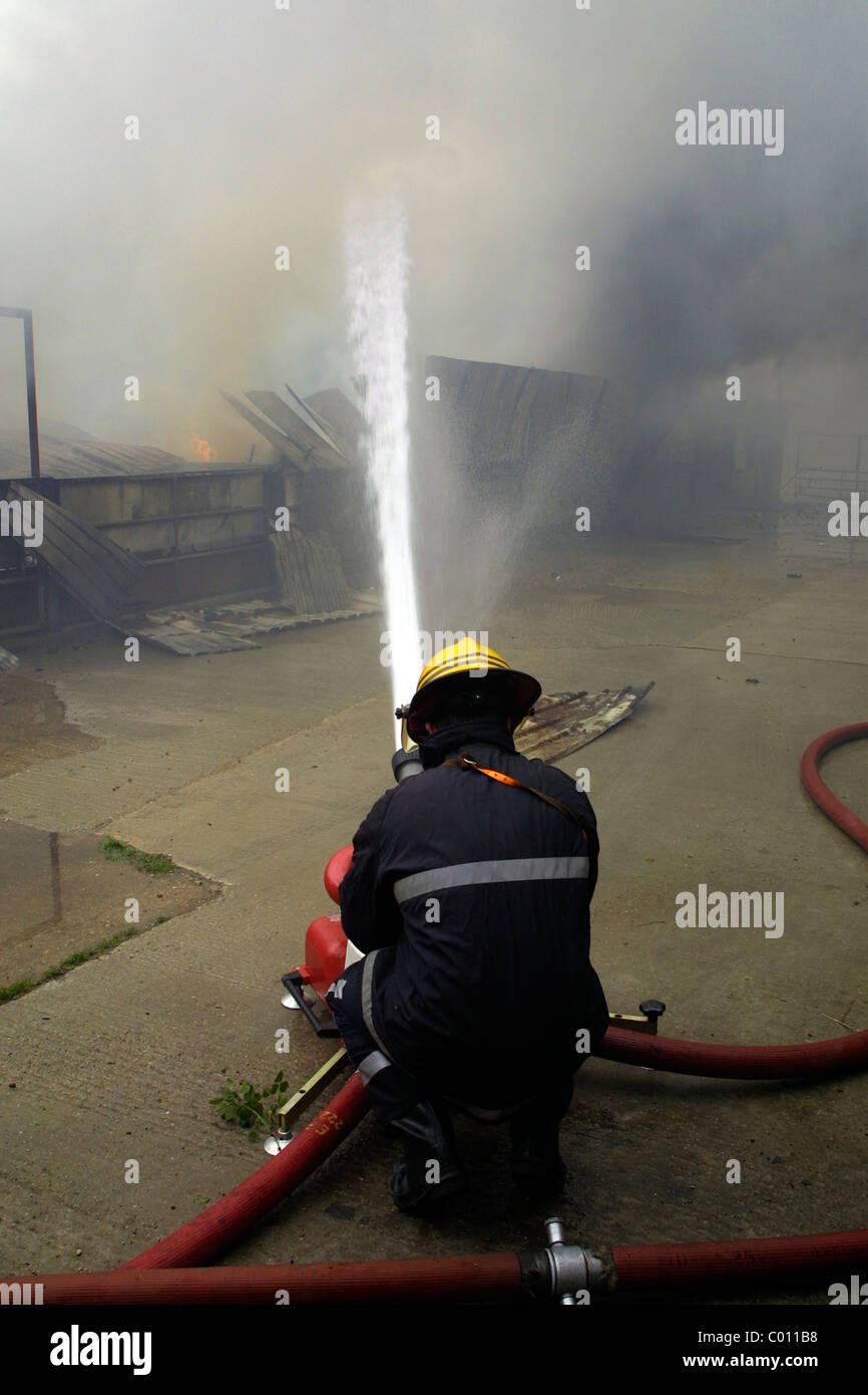 Fireman positions ground monitor at scene of a fire Stock Photo - Alamy