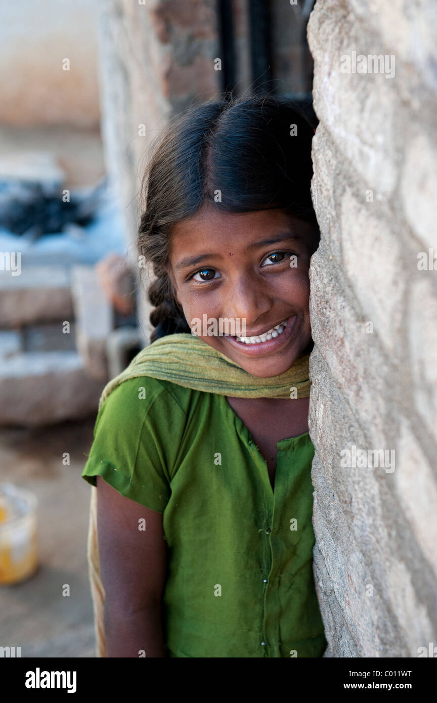 Smiling happy Indian village girl in the doorway to their house. Andhra ...