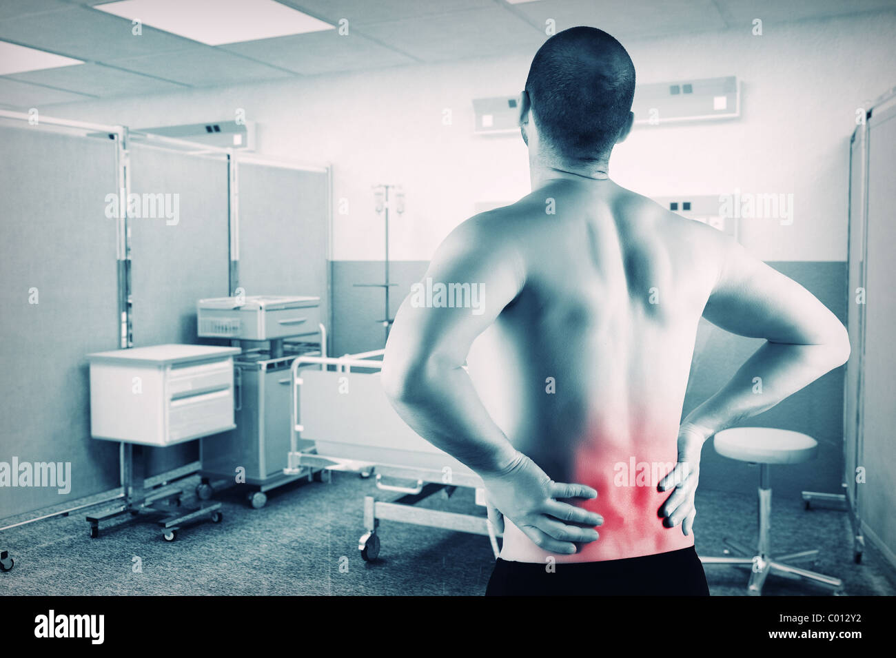 caucasian man with back pain with hospital background Stock Photo - Alamy