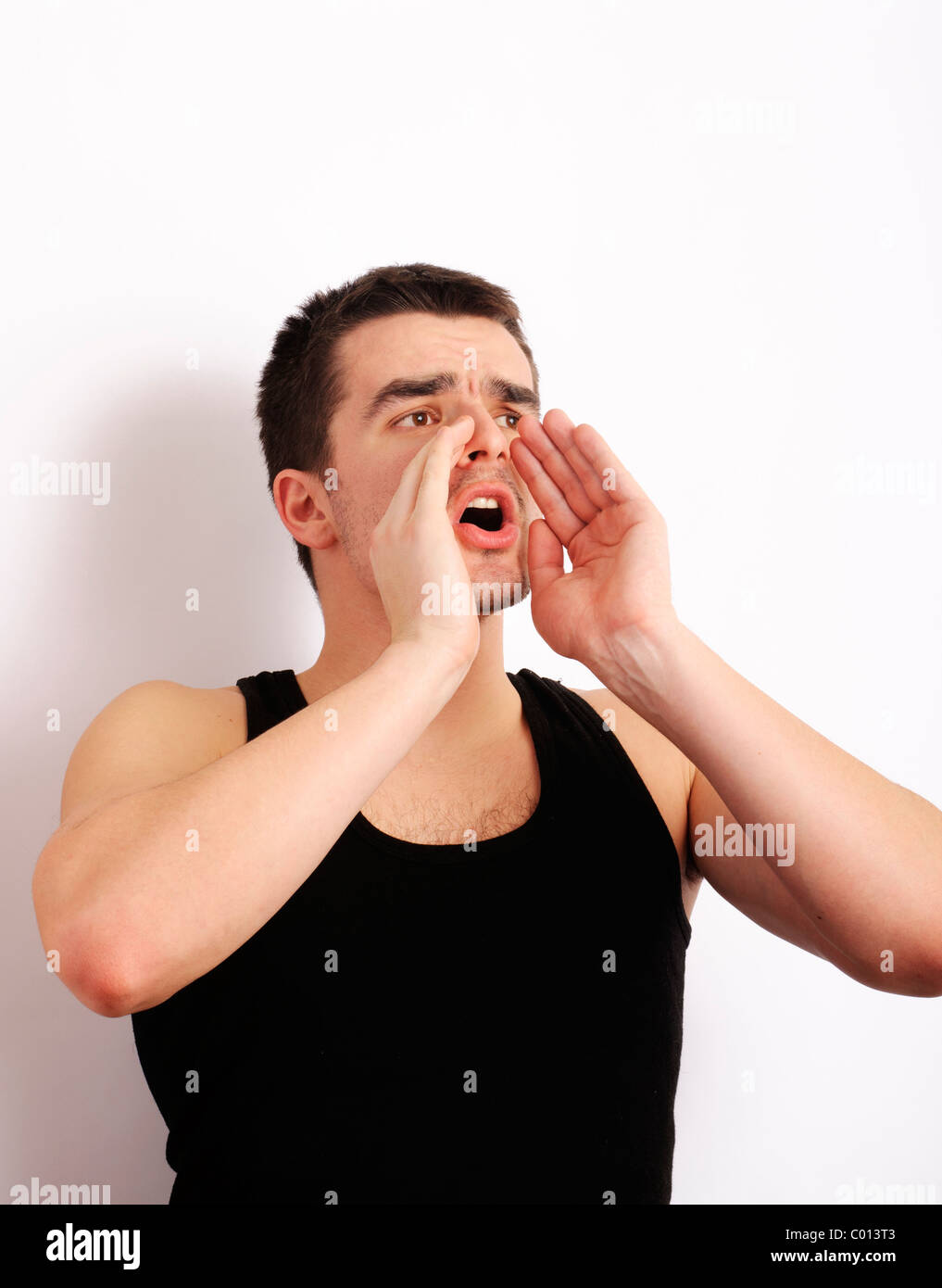 Young man shouting Stock Photo - Alamy