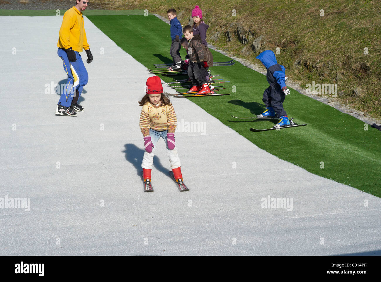 A child learns to ski on a dry Ski slope in Plymouth Devon England ...