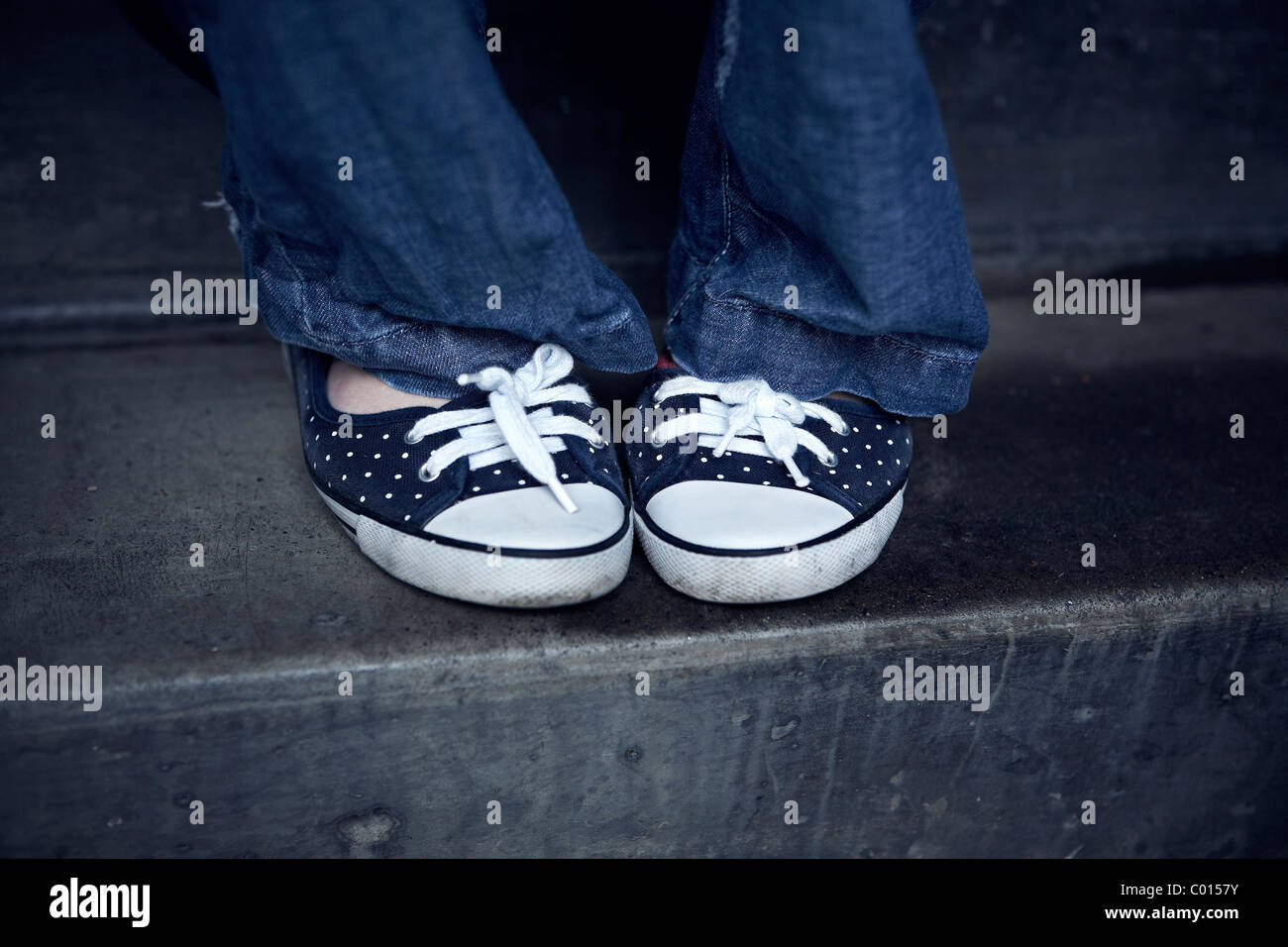 Close up of a persons feet whilse sitting on a step Stock Photo - Alamy