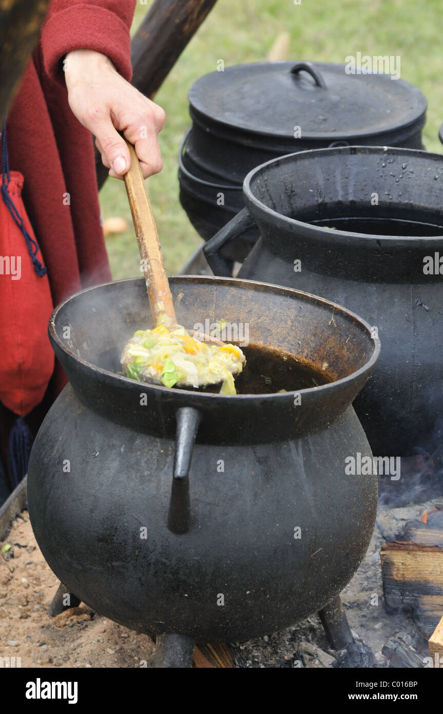 A vegetable stew cooked in a tradition metal pot over open fire Stock ...