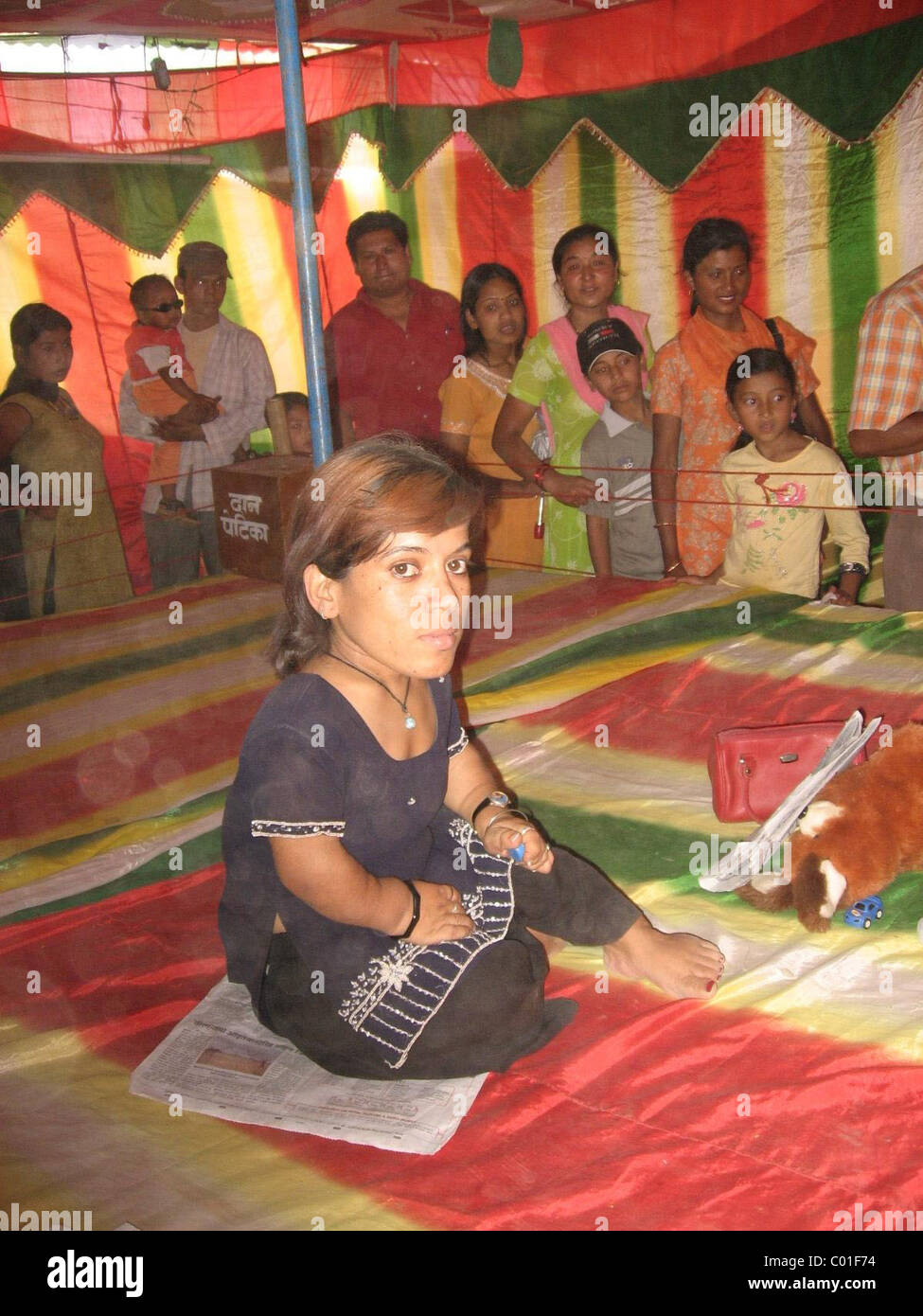 TINY PEOPLE Twenty six-year-old Manju Ghimire sits on top of a stage at ...