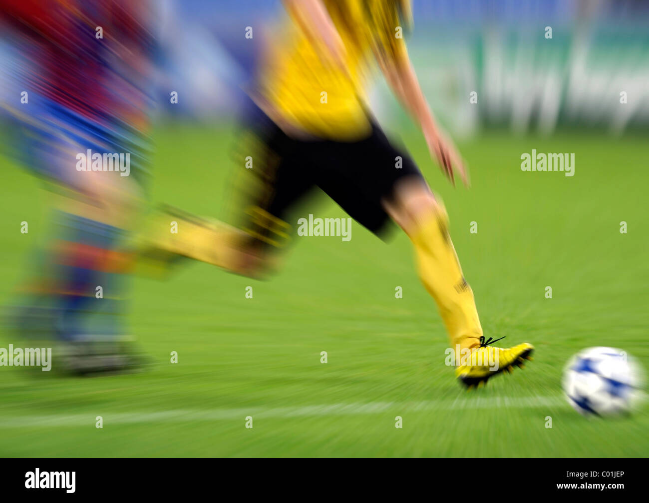 Footballer with ball in action Stock Photo - Alamy