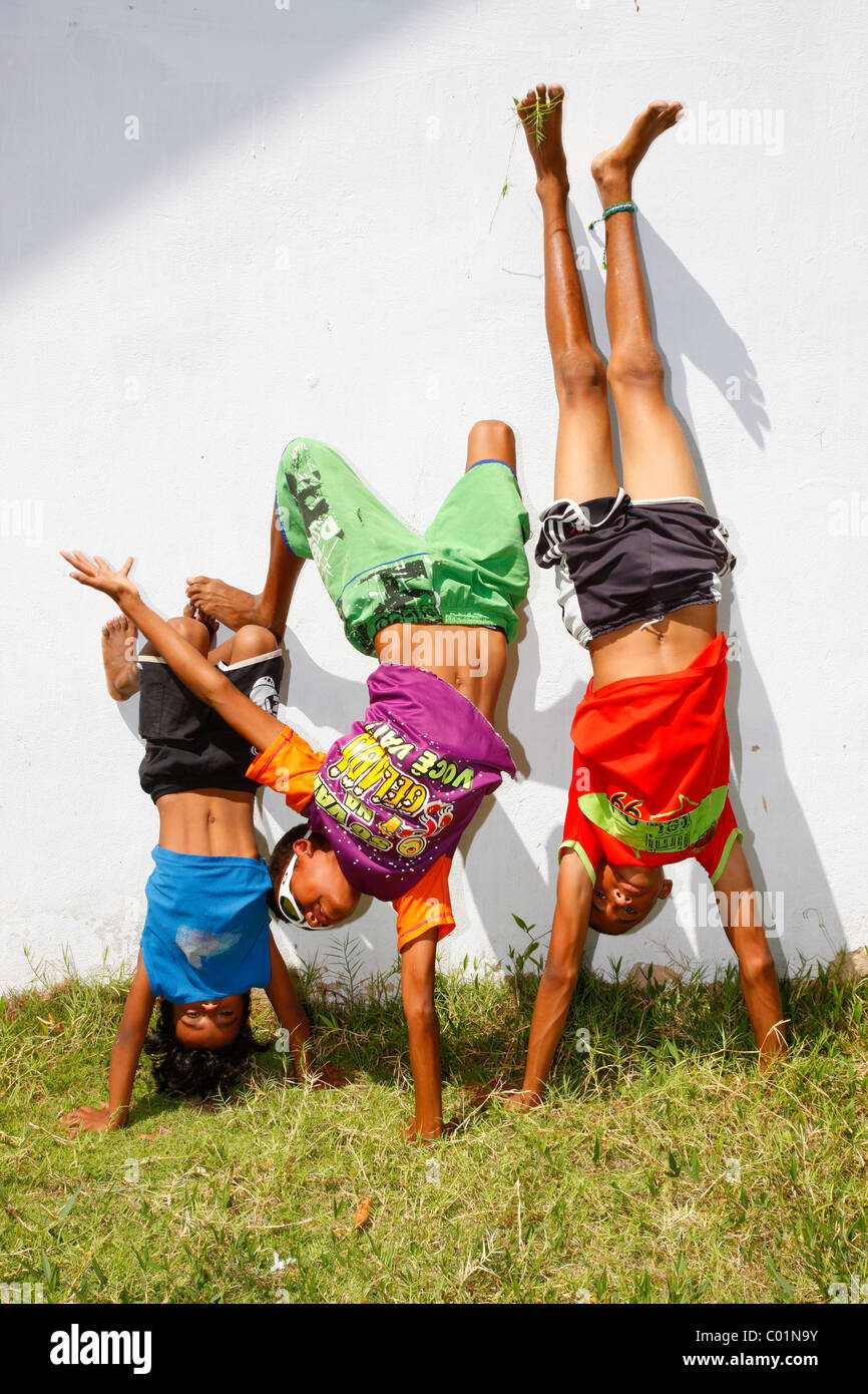 Three boys doing a handstand, Fortaleza, Ceará, Brazil, South America ...