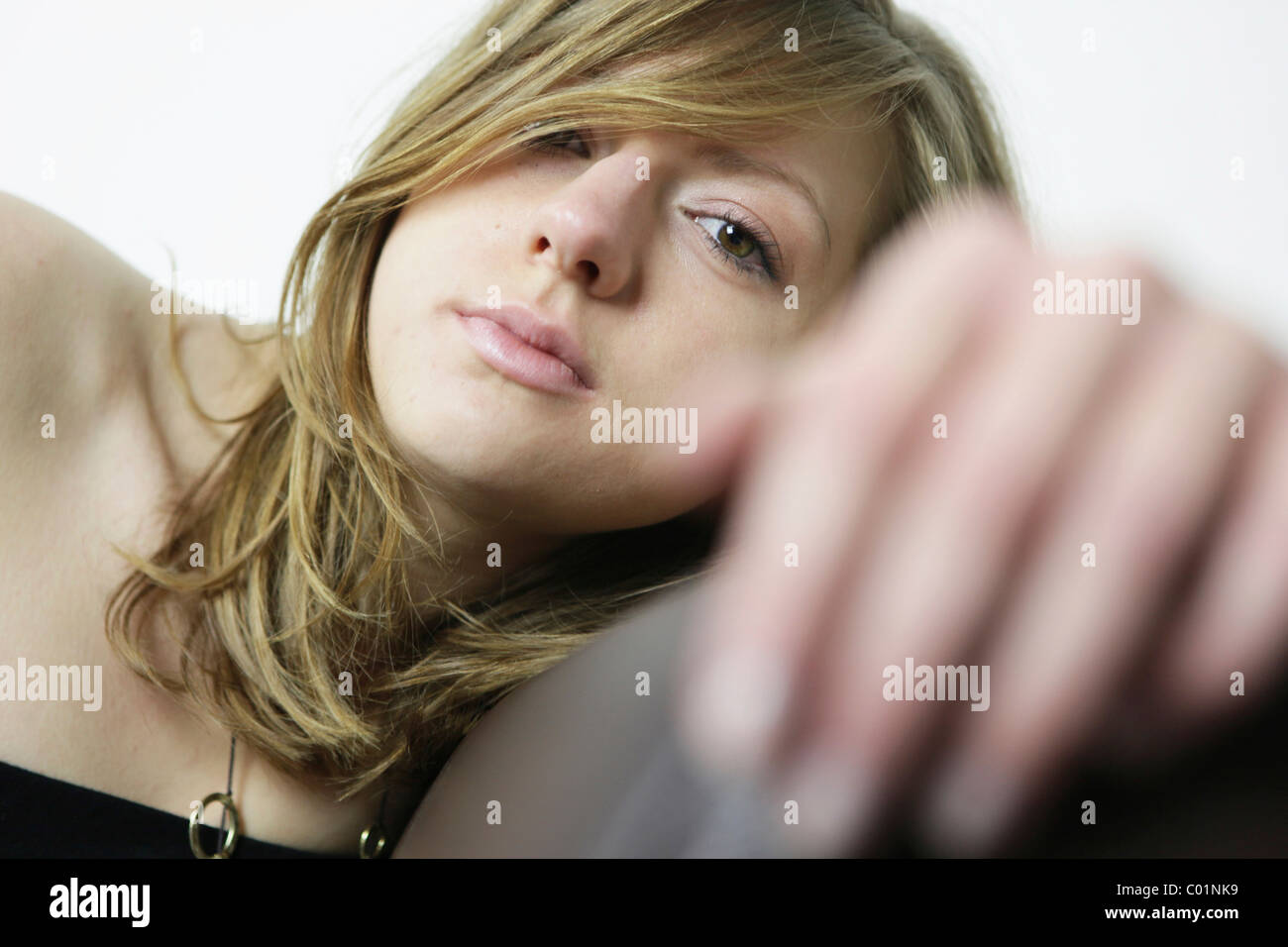 Portrait of a young woman with long hair, sensual, blurry hand Stock ...