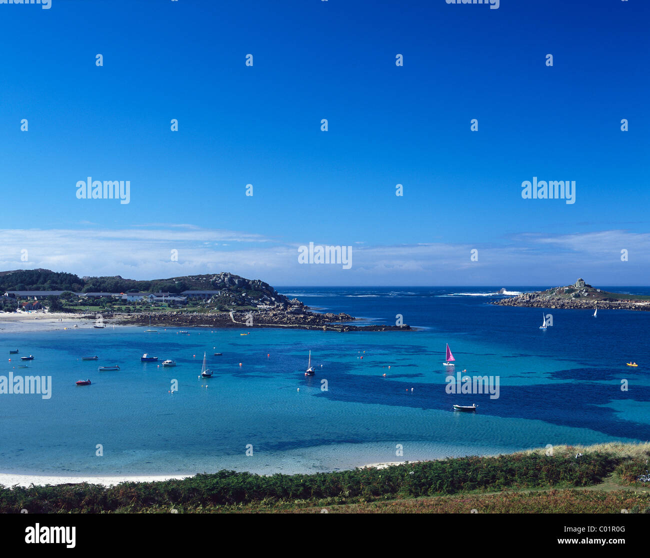 Clear blue sea surrounds the island of Tresco, Isles of Scilly, UK. Old ...