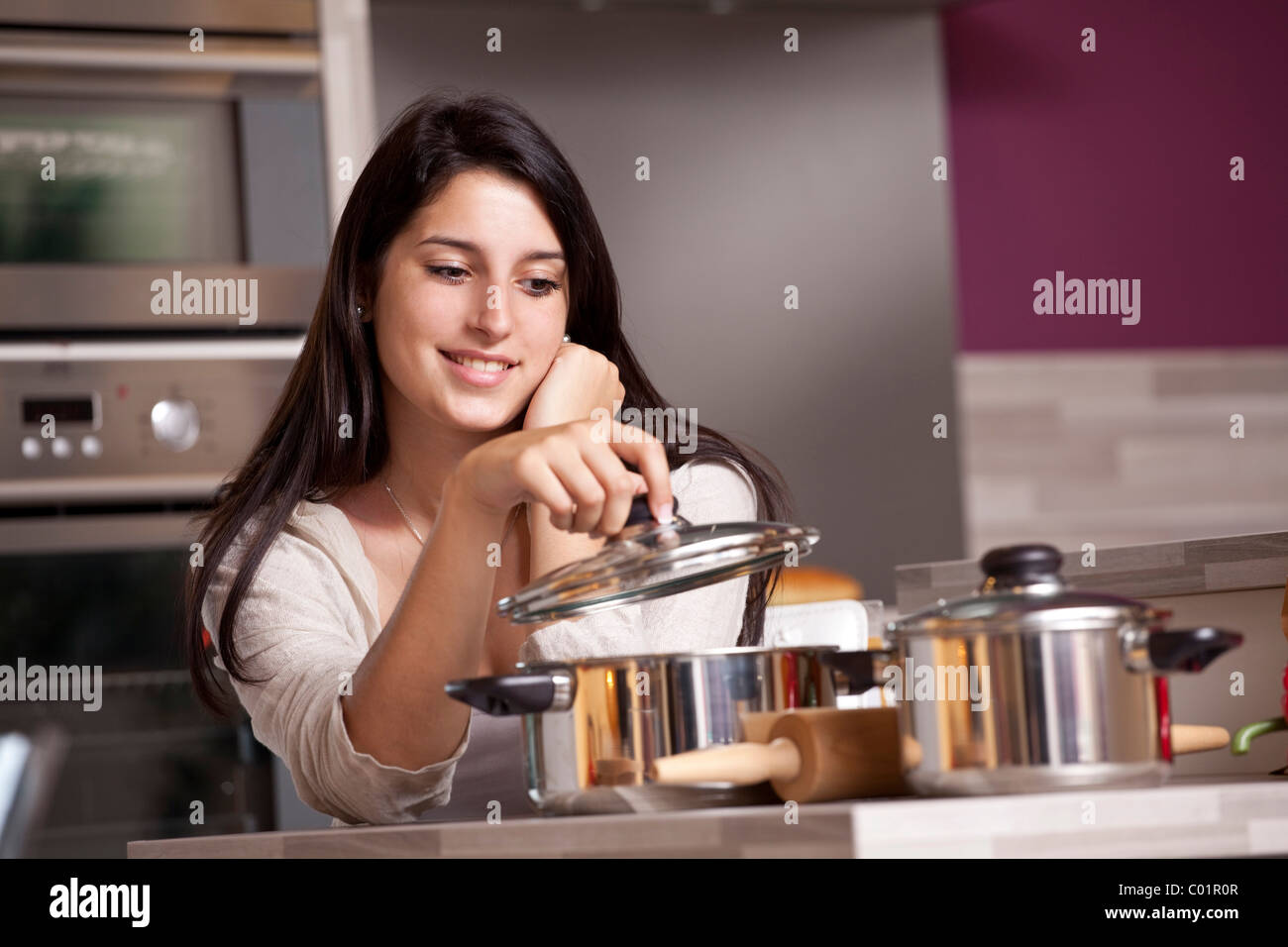 Young woman cooking a meal Stock Photo - Alamy