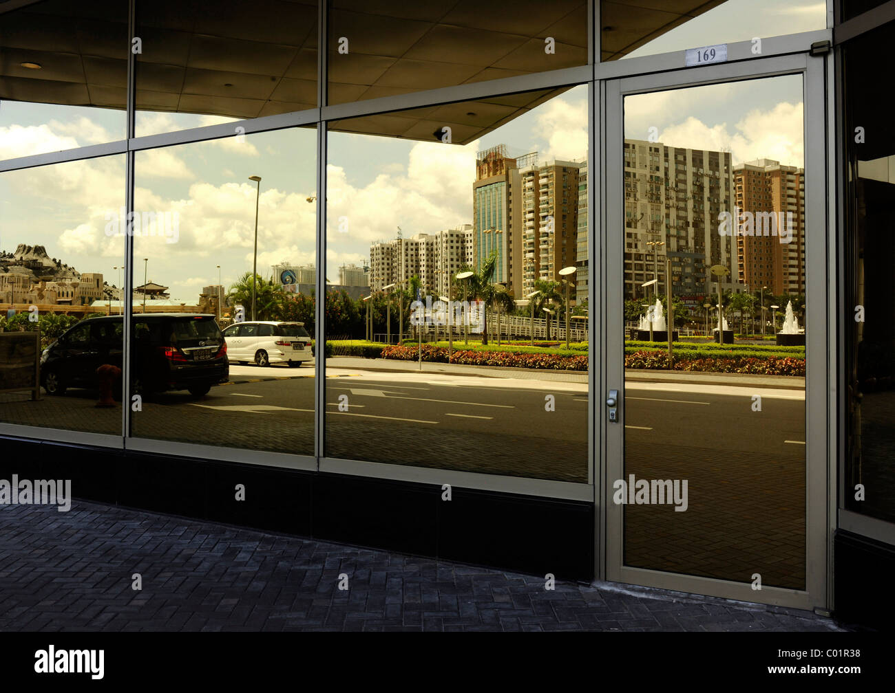 Door and glass front reflecting high-rise building, Macao, China, Asia ...