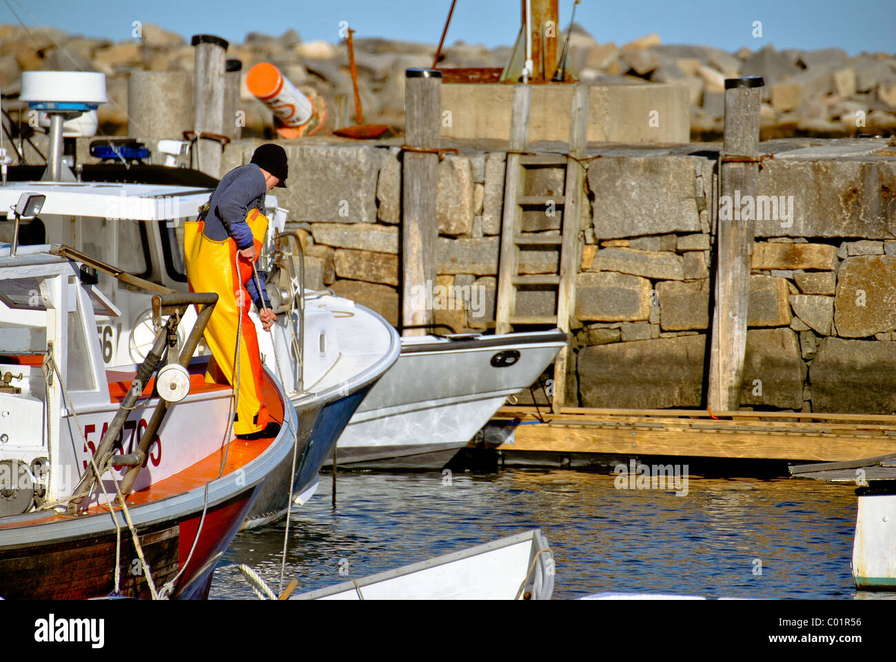 Fisherman pulling the rope out of the water Stock Photo - Alamy