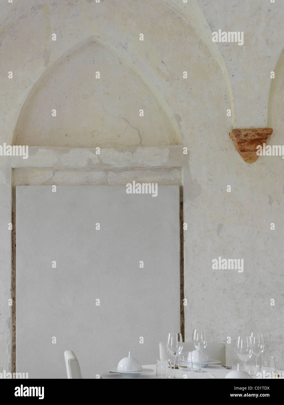 table set in dining room inside a ancient restored building of the 15th ...