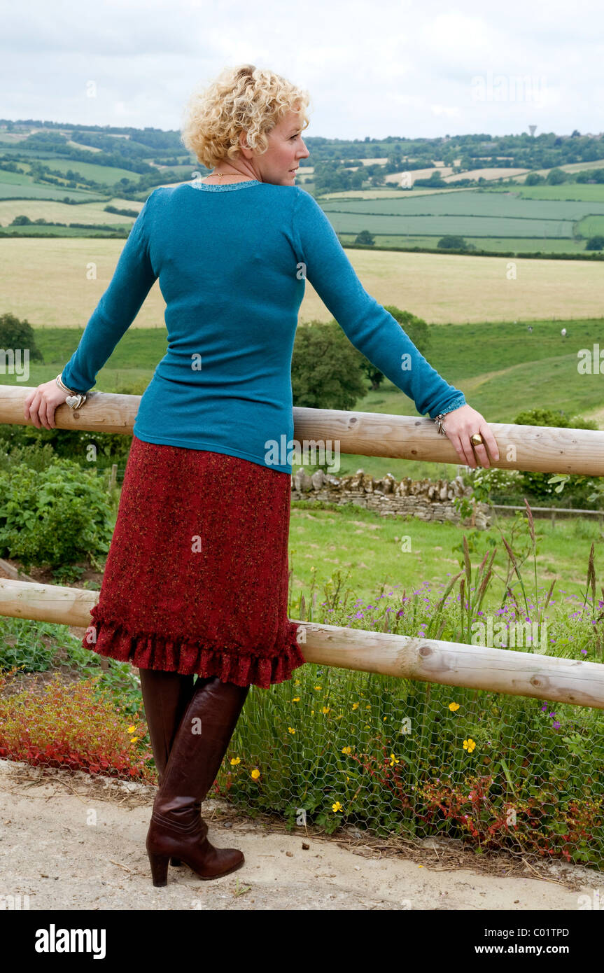 Back view of a woman looking over fields and farmland, UK Stock Photo ...