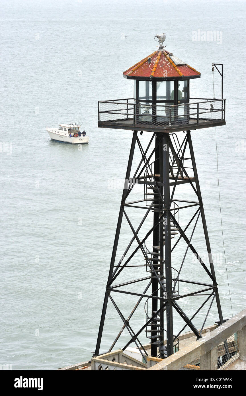 Watchtower and fishing boat at sea, Alcatraz Island, California, USA ...