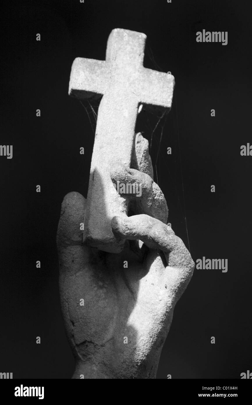 Hand holding a cross Black and White Stock Photos & Images - Alamy