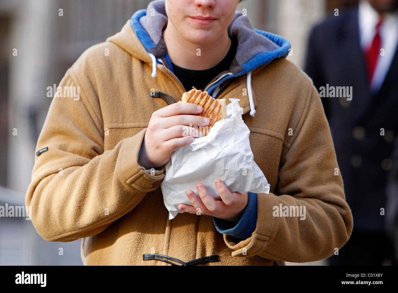 A young lad eating a panini Stock Photo - Alamy