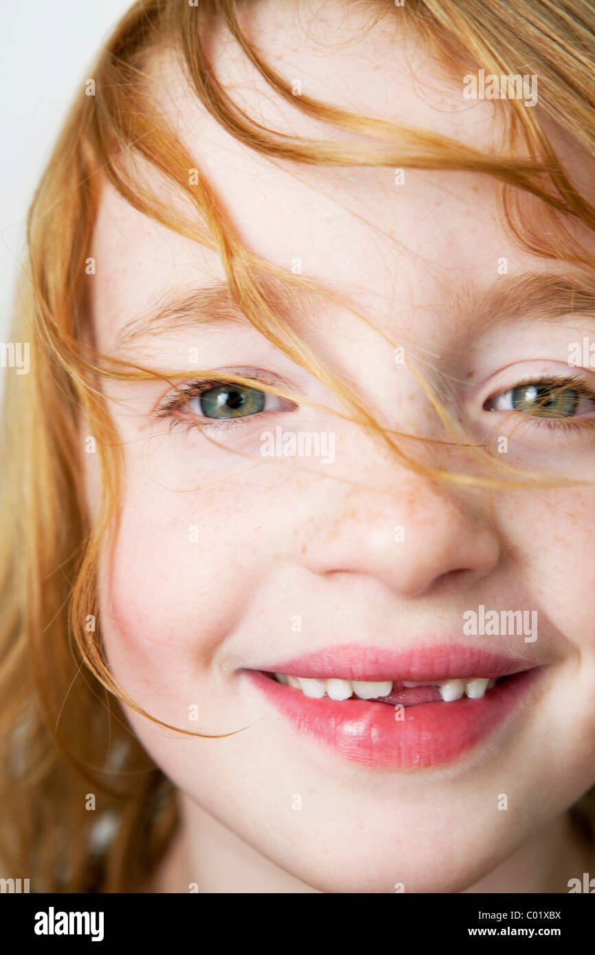Portrait of a girl with red hair with a missing tooth Stock Photo - Alamy