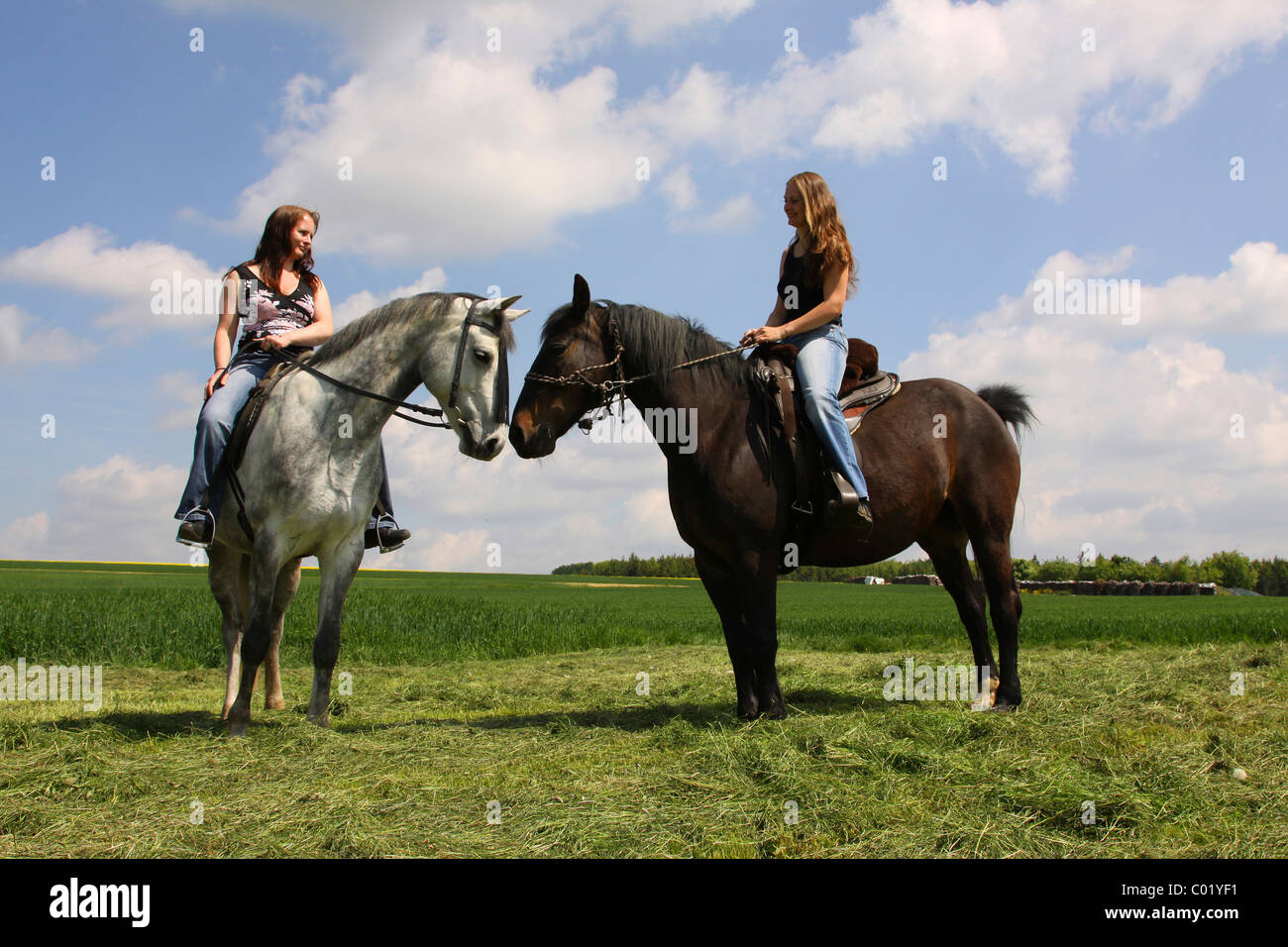 Two young women riding on horseback, Bavaria Stock Photo - Alamy Two young women riding on horseback, Bavaria Stock Photo - Alamy