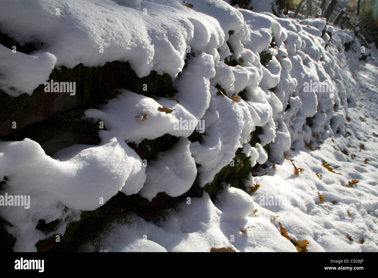 Dry stone wall with snow Stock Photo - Alamy