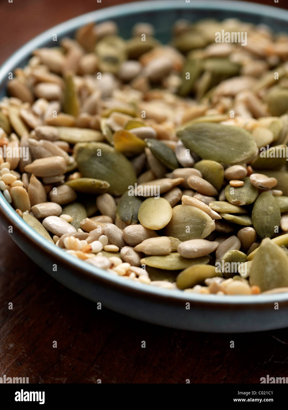 Blue bowl of various seeds mixture Stock Photo - Alamy