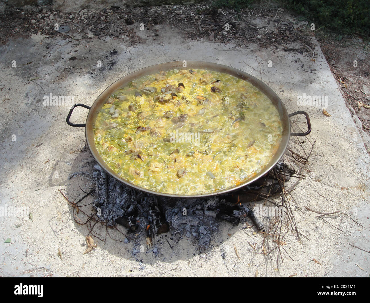 Rustic paella cooking al fresco for Spanish wedding Stock Photo - Alamy