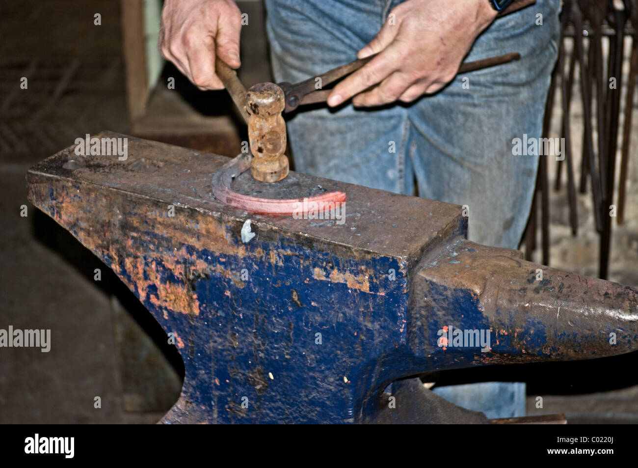 Red hot iron being beaten into shape Stock Photo - Alamy
