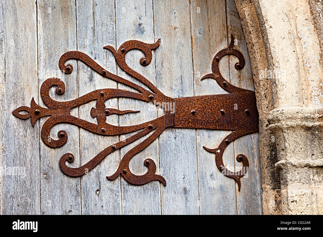 Ornate hinge on old wooden door Beynac-et-Cazenac Dordogne France Stock ...