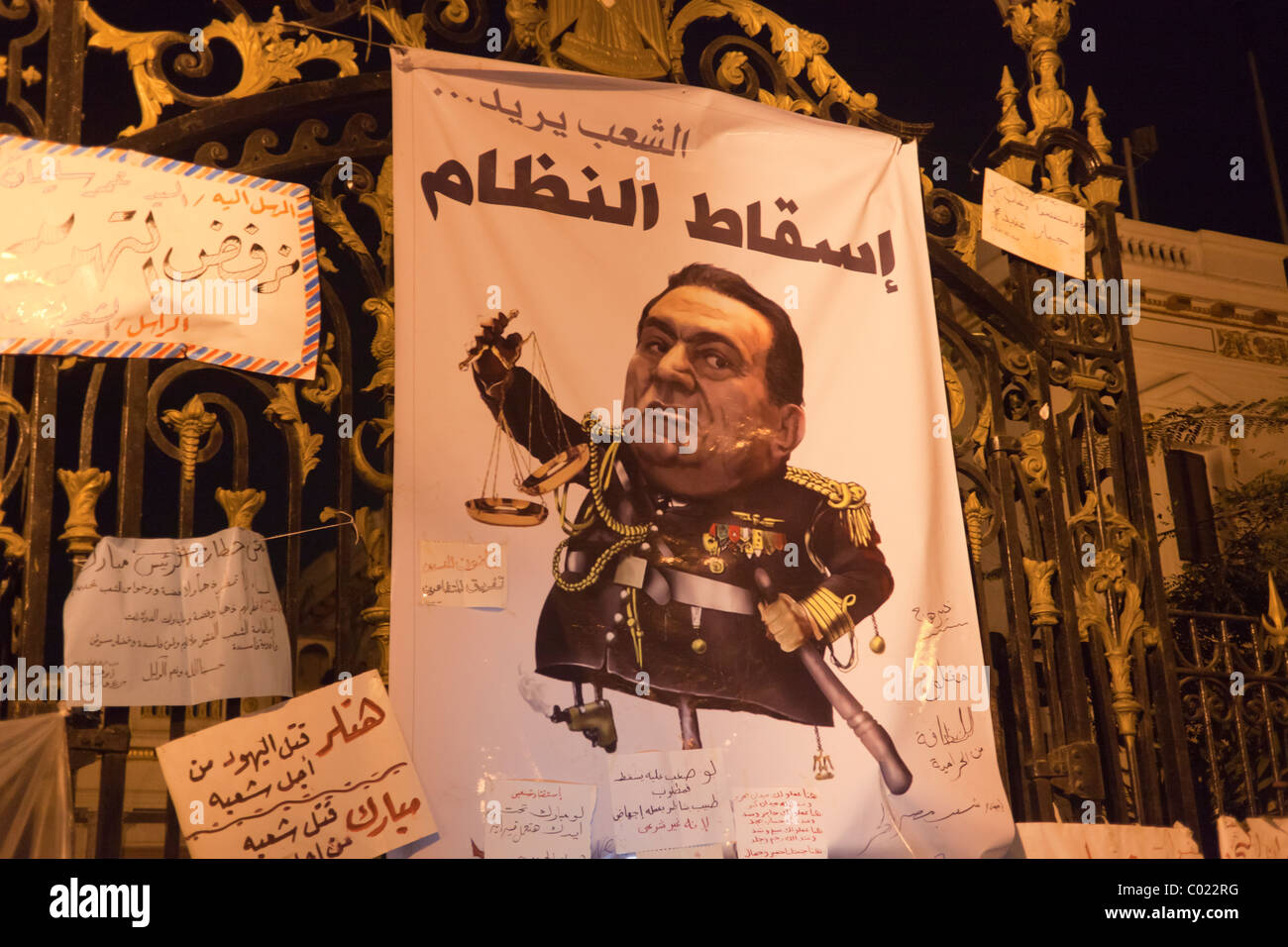 poster of Mubarak on parliament gate saying Abolish the Regime, Cairo ...