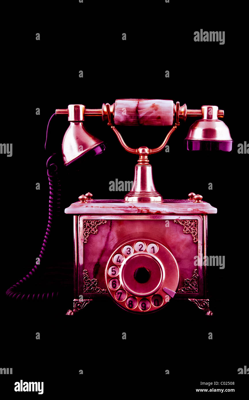 Antique telephone in pink and purple tones with black background Stock ...
