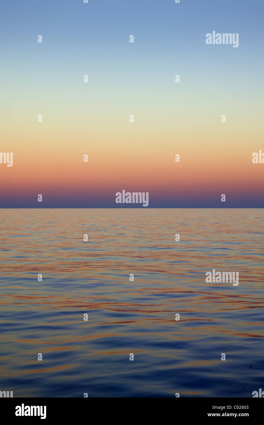 Beautiful sunset sunrise over blue sea ocean in red sky Stock Photo - Alamy