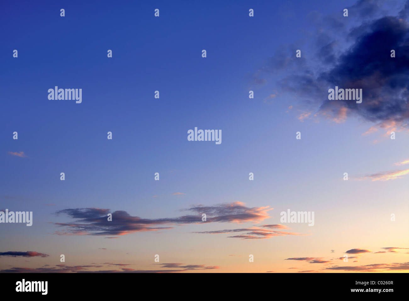 Blue sky background with clouds at sunset Stock Photo - Alamy