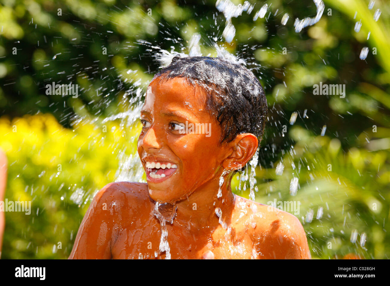 Boy being sprayed with a water hose, Fortaleza, Ceará, Brazil, South ...