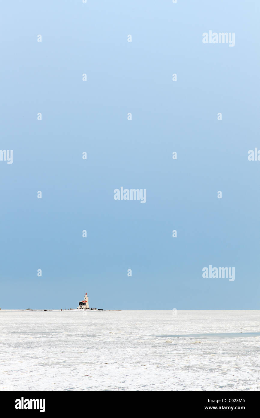 Frozen sea with lighthouse at sunset Stock Photo - Alamy