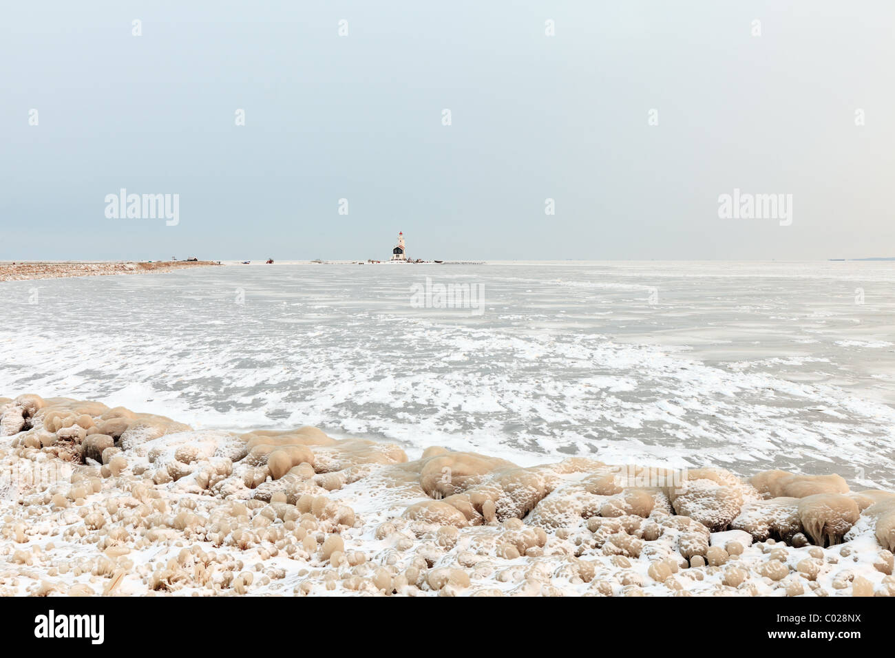 Dutch winter landscape with frozen sea and lighthouse Stock Photo - Alamy